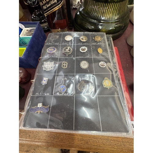 A badge collection including silver badges, enamel badges etc