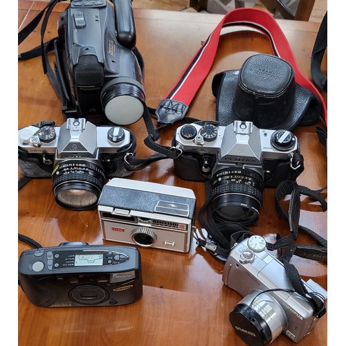Assorted cameras: two Pentax film SLRs, an Olympus digital camera, a ...