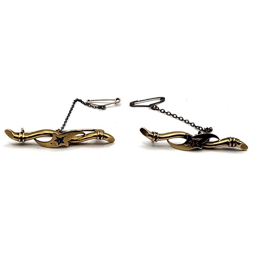 Two 15ct stamped yellow gold tie pins with a central diamond chip and ...