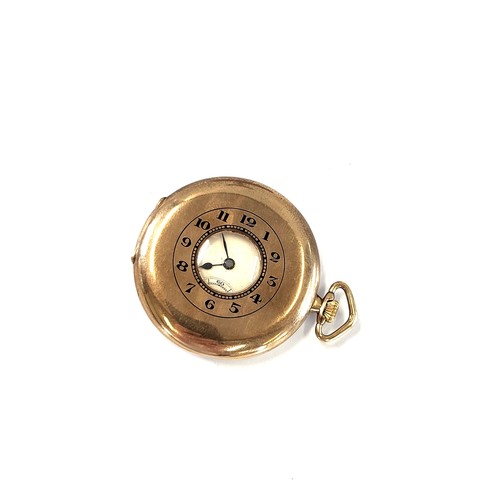 A turned wooden fob watch stand and a 9ct rose gold fob watch (watch ...