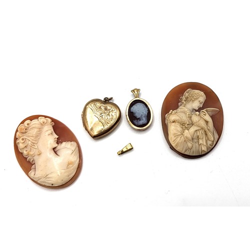 A pair of unset cameos, one depicting a maiden cradling a dove, the ...
