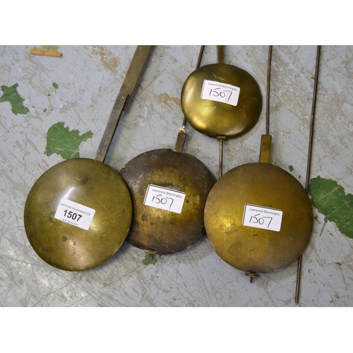 Group of four longcase clock pendulums and three weights