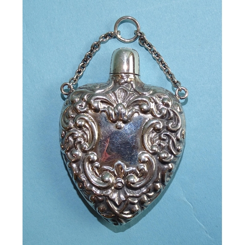 A small sterling silver heart-shaped flask with embossed decoration and ...