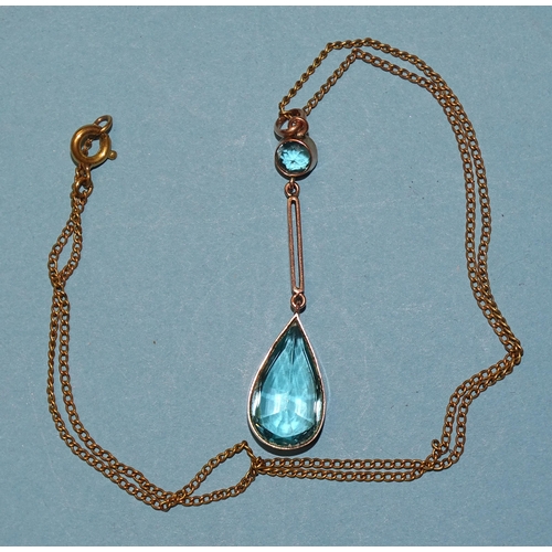 An Edwardian pendant millegrain-set a pendeloque-cut blue stone below a ...