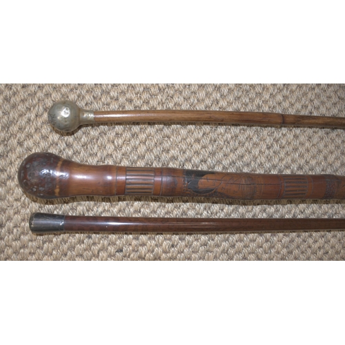 An RAF swagger stick, a silver-mounted hardwood cane and a carved ...