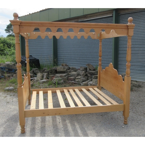 Victorian style pine four poster bed, with arched head and foot boards, turned columns and finials,