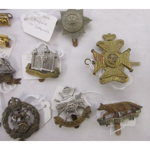 Collection of mostly British military army cap badges, pin badges etc ...