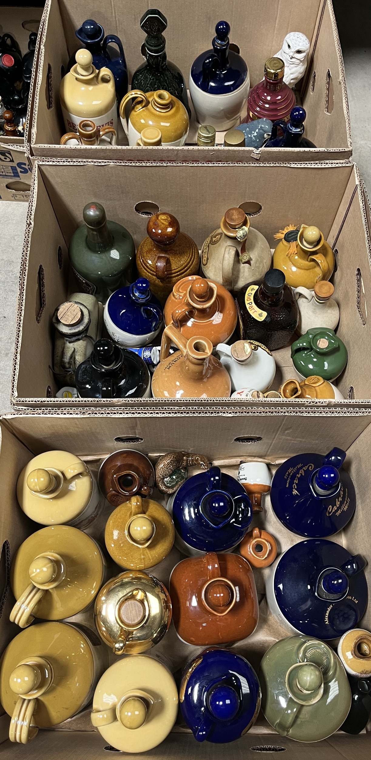 Large collection of empty whisky flasks/decanters, incl. Disquaebach the grand liqueur, blended and