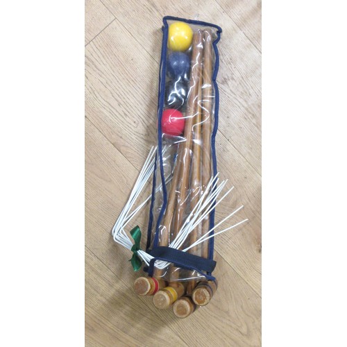 Croquet set with four mallets, hoops and balls, on trolley and a child ...