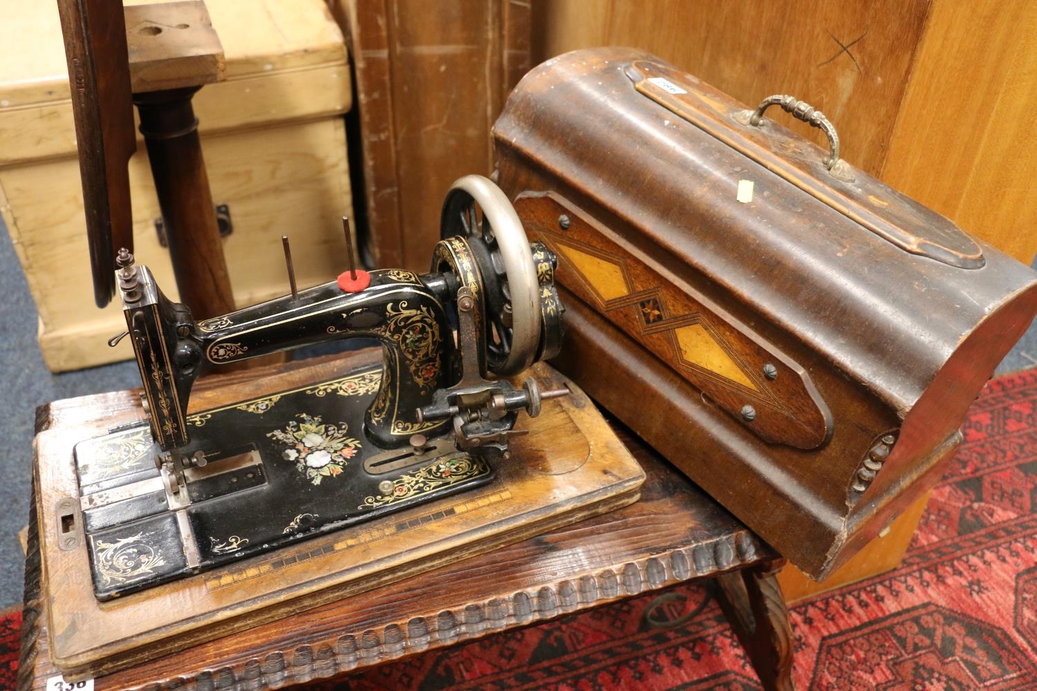 Cased sewing machine with gilt and mother of pearl decoration.