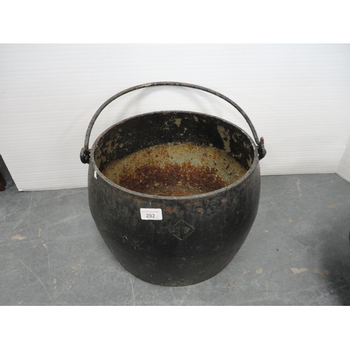 Two painted iron cauldrons with swing handles and a wicker basket. (3)