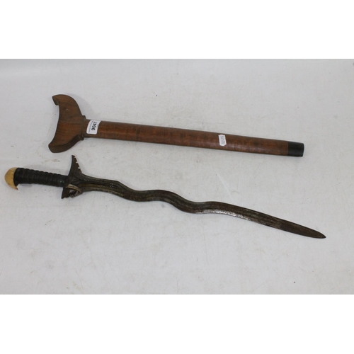 Malaysian kris with typical ornate flamberge blade, white metal wire ...