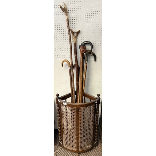 Wicker stick stand with assorted sticks and walking canes