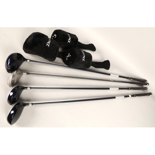 Four assorted golf clubs