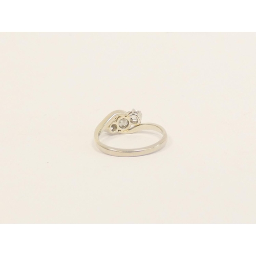 Diamond cross-over ring with three brilliants, the largest approx .30ct ...