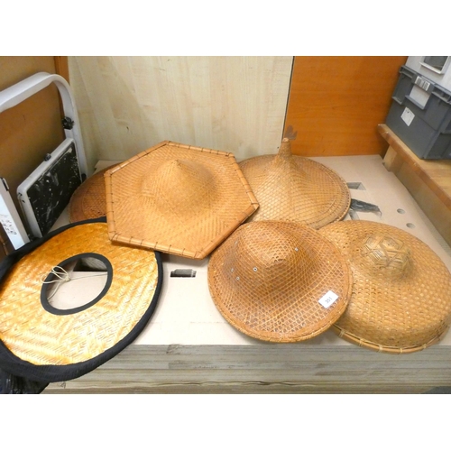 Various antique Chinese sun hats made of rush.