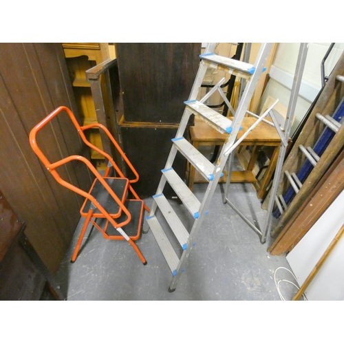 Two sets of modern step ladders.