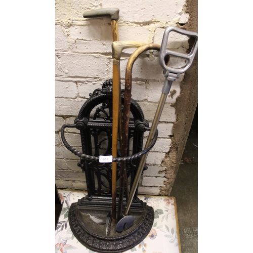 Wrought iron stick stand with three walking sticks and a shooting stick.