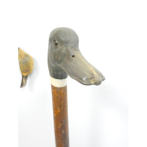 Two fine 20th century duck head walking sticks with carved horn handles ...