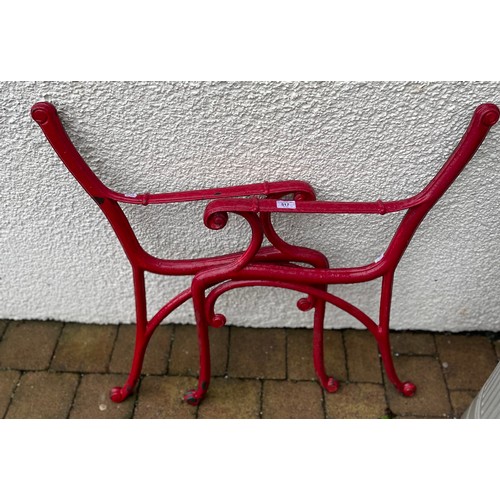 Pair of red painted cast metal bench ends.