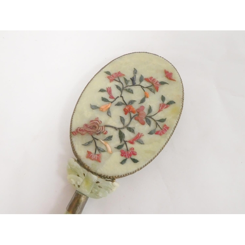 An early 20th century Chinese jade hand mirror; the oval jadeite ...