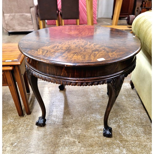 Ebonised mahogany circular table on ball & claw feet, the top swivels ...