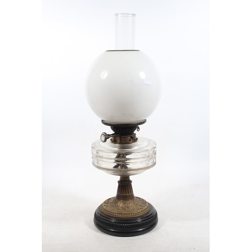 Paraffin lamp with glass shade and reservoir.
