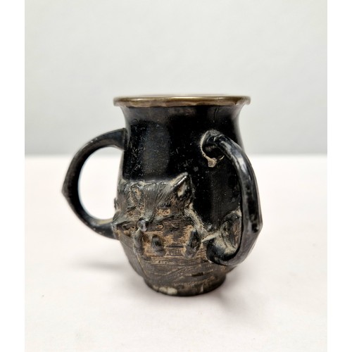 Cold painted brass loving cup decorated with pigs peering over a fence ...