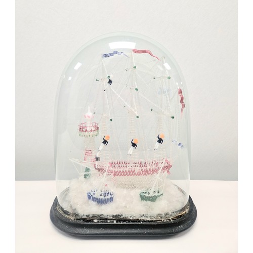 Spun glass ship model under glass dome.