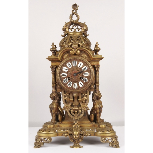 Victorian ornate brass mantel clock, with double fish finials, the dial ...