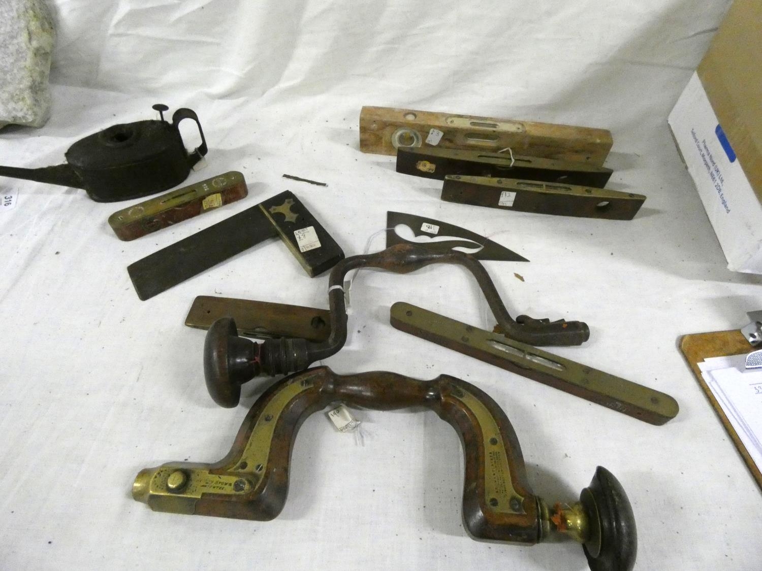 Box of vintage spirit levels and hand tools.