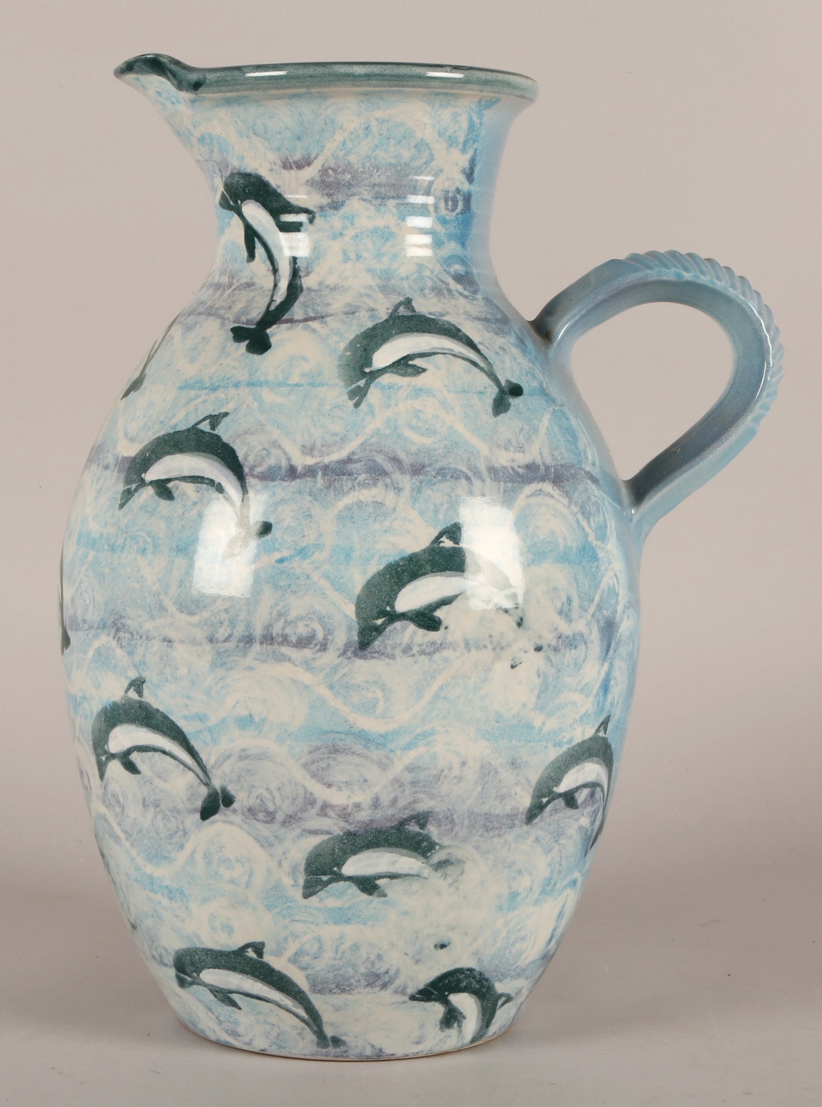 Scottish Pottery Dolphin patterned water jug, signed M.Rennie to base ...