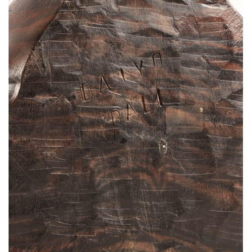 Balinese carved hardwood figure feeding a rooster, 29cm high.