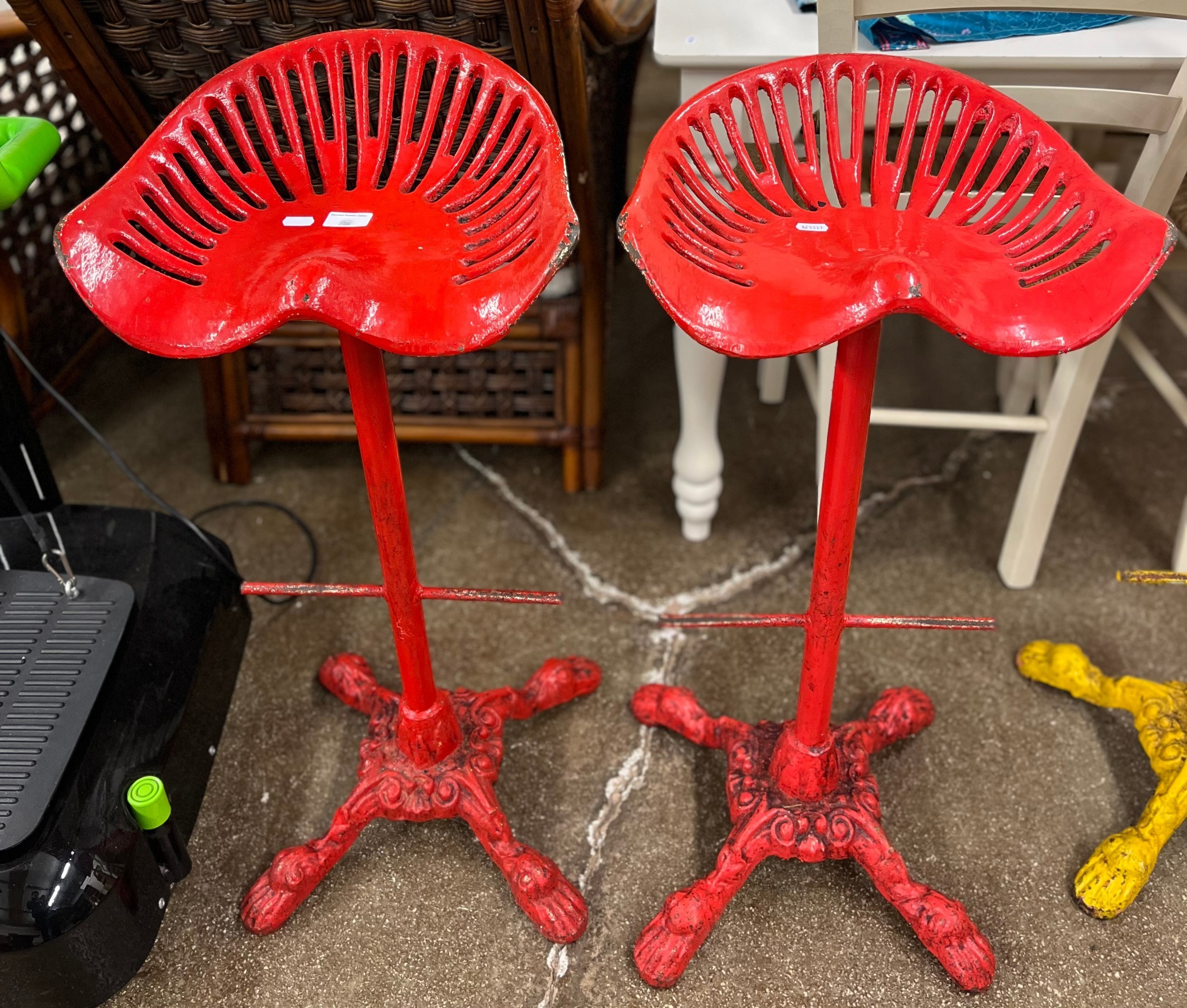Pair of red tractor seat stools.