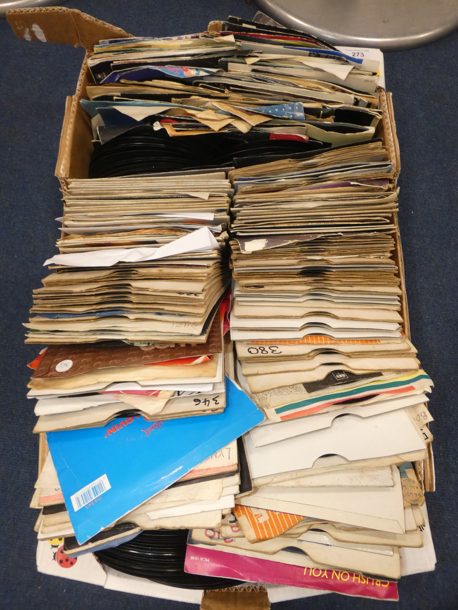 Box containing a large collection of records, mainly 45rpm singles.