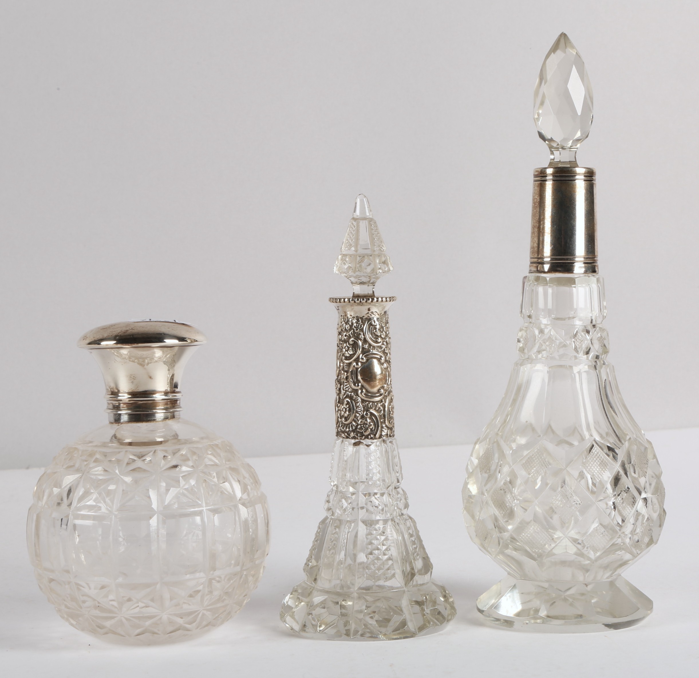Three silver mounted cut glass dressing table bottles (3)