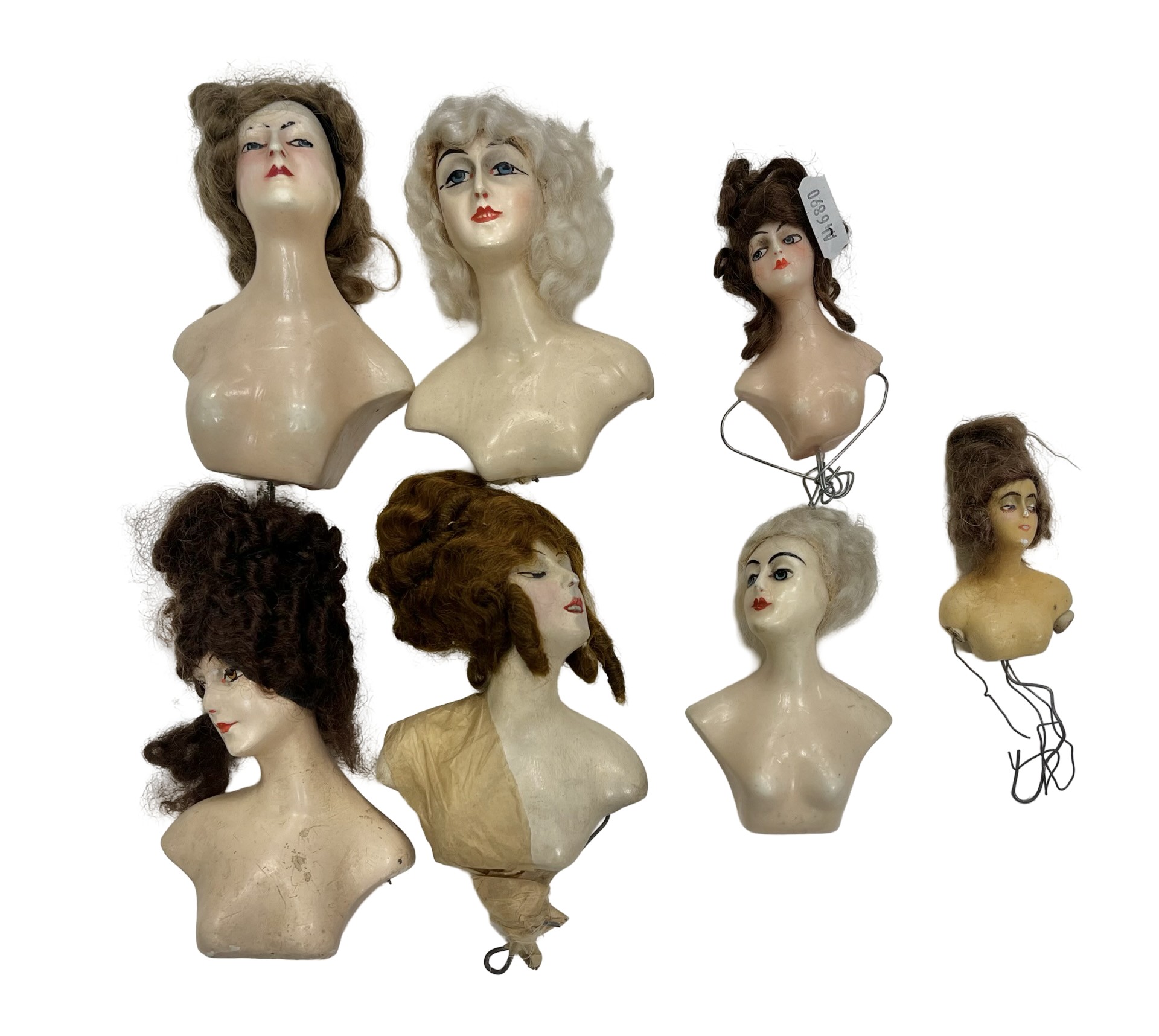 Collection of seven plaster cast half dolls.