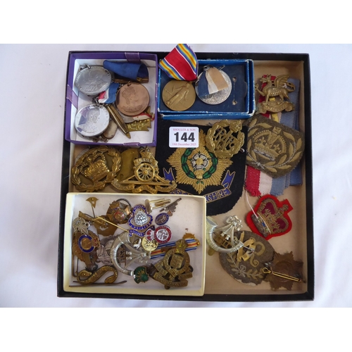 Collection of military uniform badges, commemorative medallions etc.