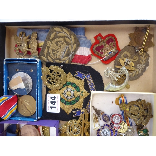 Collection of military uniform badges, commemorative medallions etc.