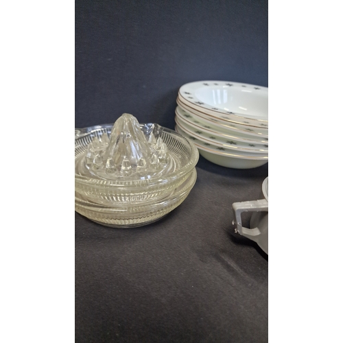 A collection of vintage glass kitchen ware. Two glass lemon squeezers ...