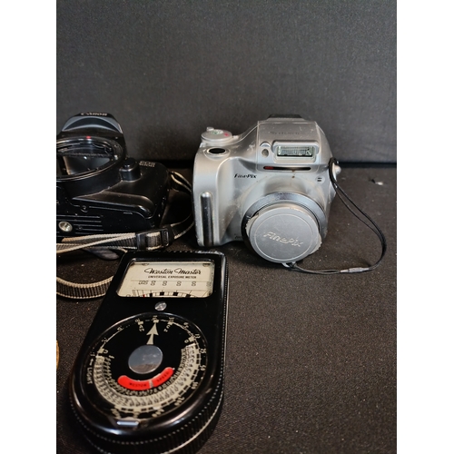 Canon film camera, Fujifilm digital camera and a exposure meter