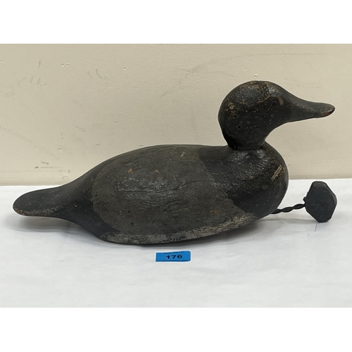 An American carved wood and painted duck decoy. Lead weighted. 15" long.