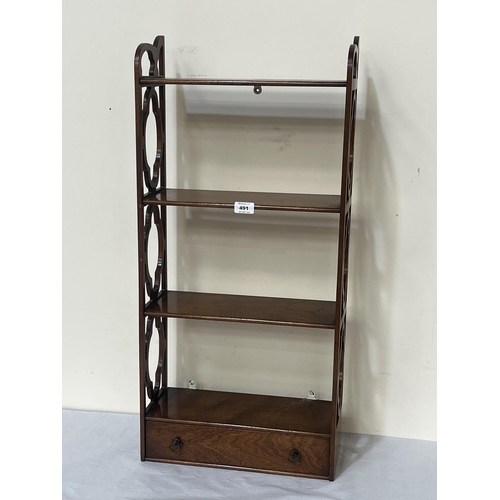 A set of mahogany wall shelves with fret carved sides and base drawer ...
