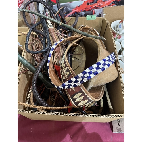 A box of whips, ethnic mask etc.