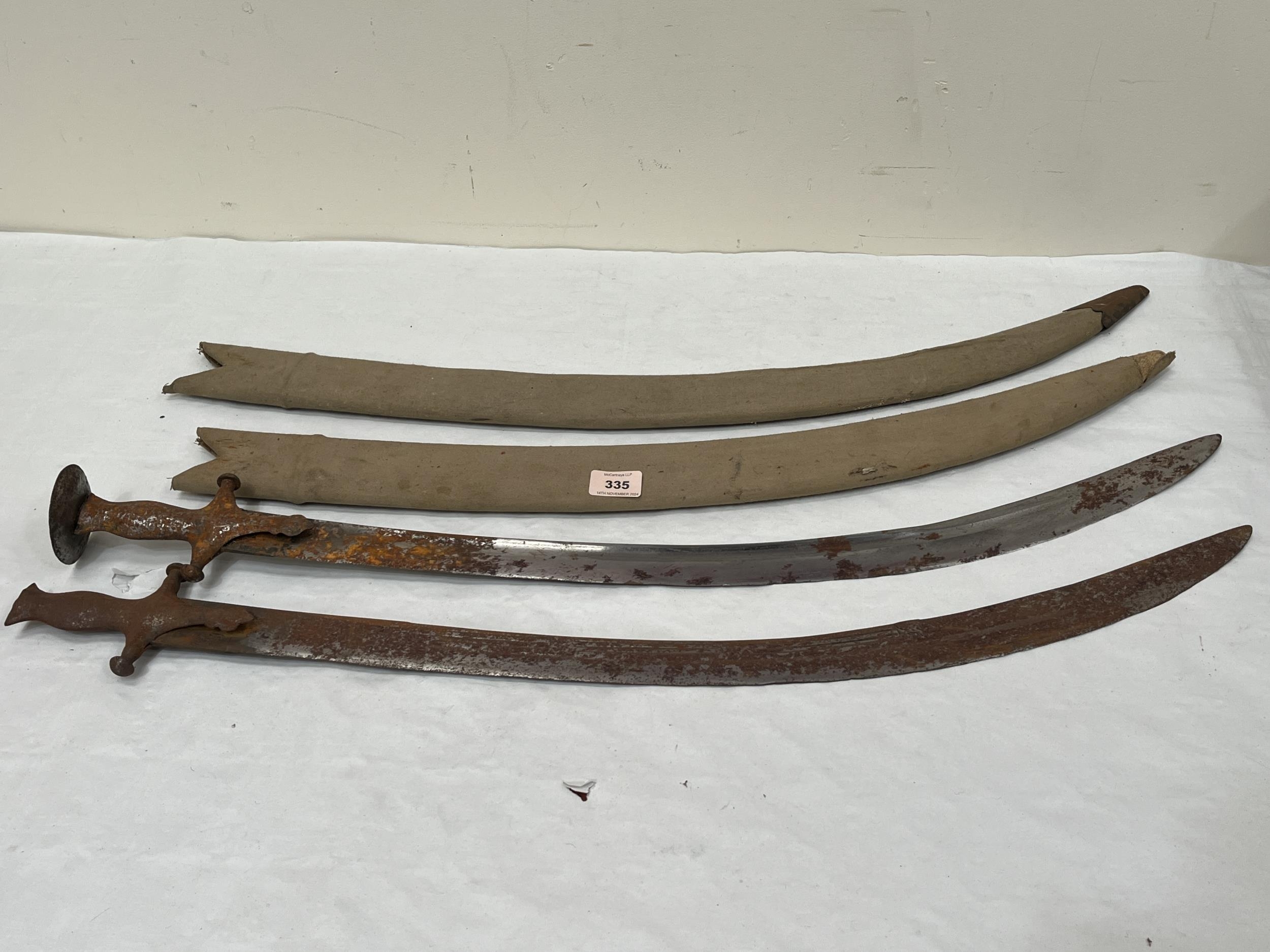 A pair of Indian Talwar sabres, 36" long. Distressed, one lacking terminal.