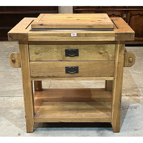 An oak butchers block with two drawers, the top inset with a granite ...