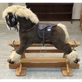 A Merrythought rocking horse on trestle stand. The stand 40" long