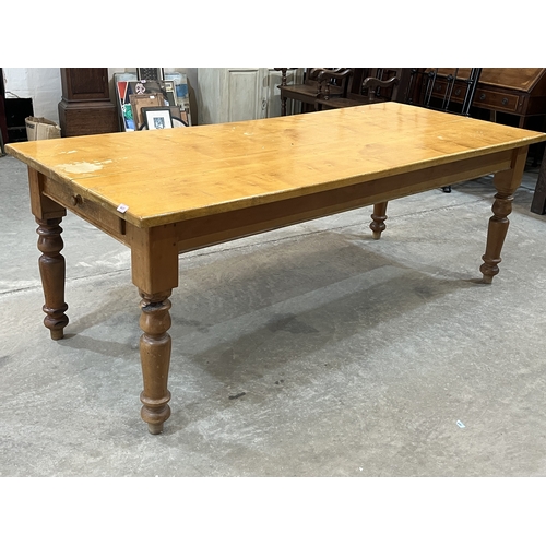 A pine and beechwood kitchen table with frieze drawer. 84" long