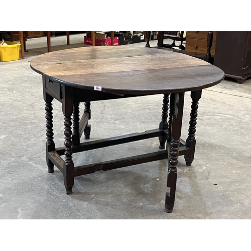 A James II joined oak gateleg table with frieze drawer, raised on ...