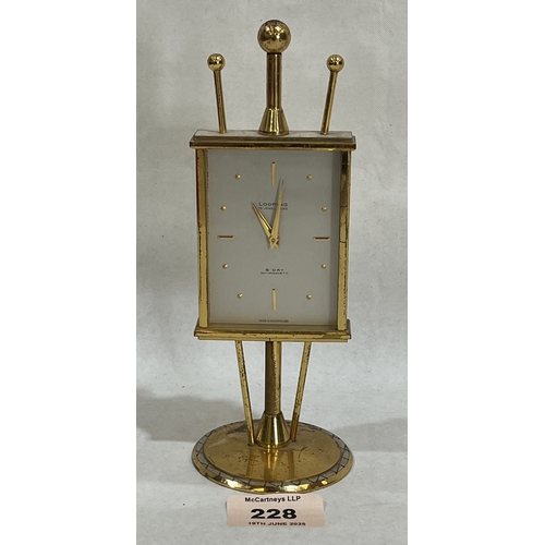 A 1950s Looping modernist design gilt brass alarm clock. 7¼" high
